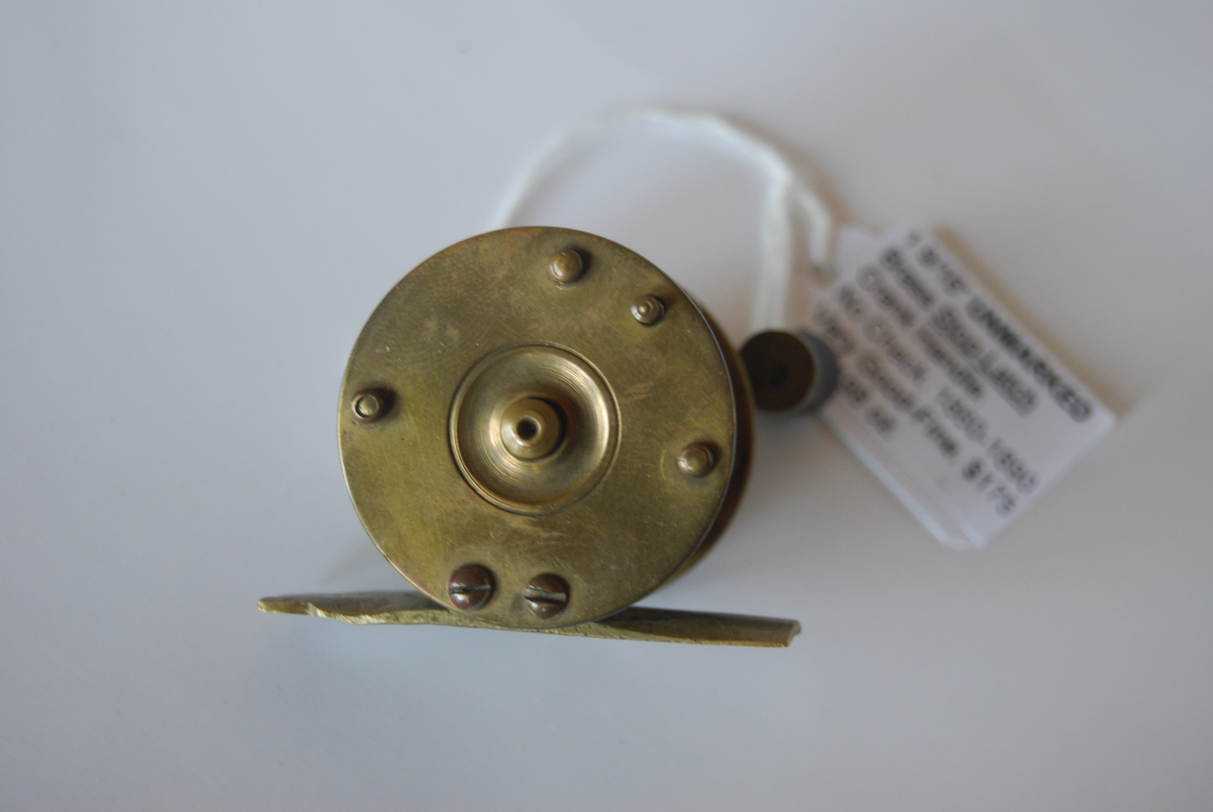1 9/16” UNMARKED Brass Stop-latch reel. 1 1/4 in. pillars; 3 1/4 oz. No ...
